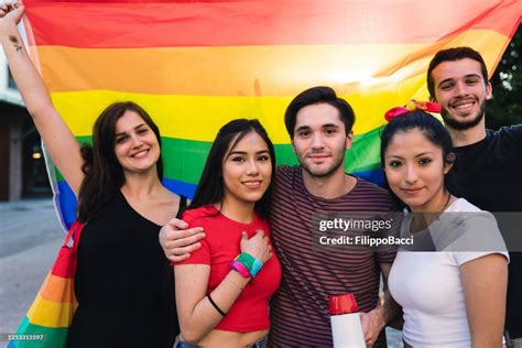 Five Friends Together Against A Rainbow Flag During An Lgbtqi Pride