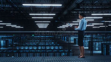 Data Center Engineer Using Laptop Computer Server Farm Cloud Computing Specialist Facility With