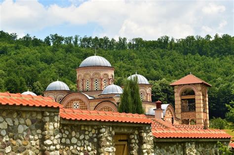 Premium Photo Built Structure By Trees And Building Against Sky