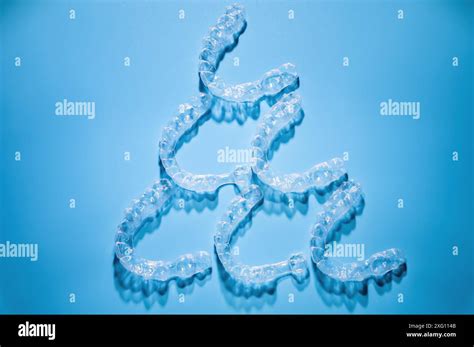 Close Up Invisible Aligners On A Blue Background In The Shape Of A