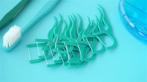 Dental Floss Picks Placed Aesthetically On A Blue Background For An Appealing Visual Stock
