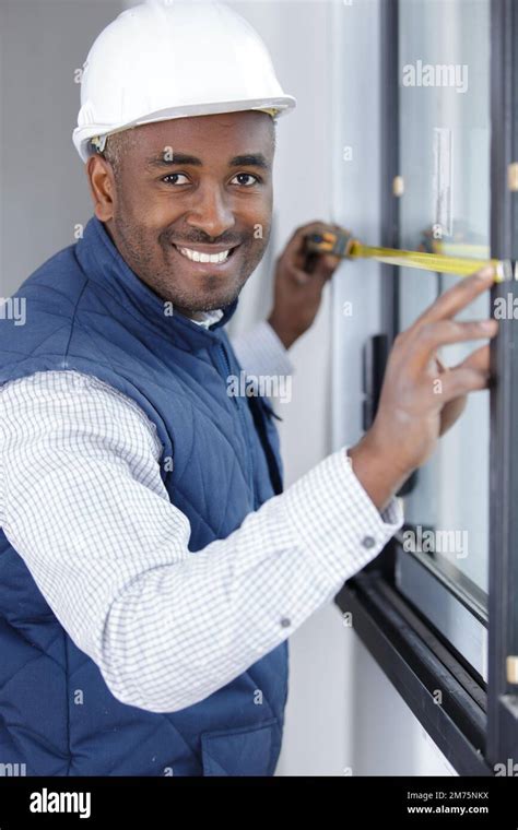 Man Measuring Window Prior To Installation Of Roller Shutter Outdoors Stock Photo Alamy