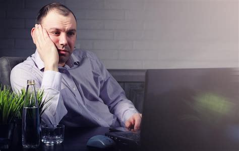 Premium Photo Man At Table And Working On Laptop