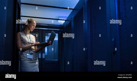 It Engineer Standing Before Working Server Rack Doing Routine