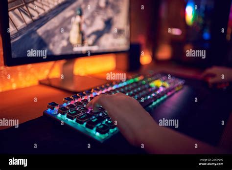 Close Up Hands Shot Showing A Gamer Pushing The Keyboard Buttons While Playing An Online Video