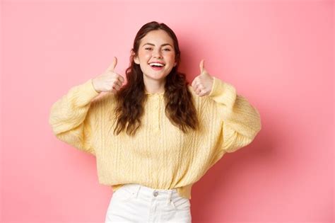 Premium Photo Portrait Of A Smiling Young Woman Against Pink Background
