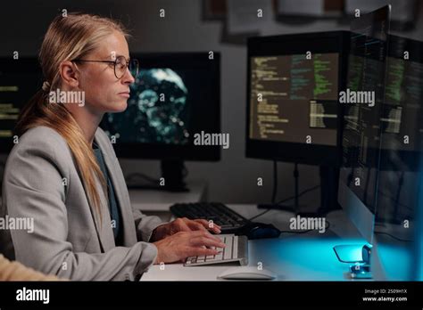 Side View Of Young Serious Woman Concentrating On Solving Technical