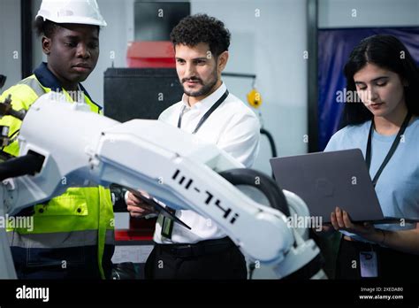 Technicians Are Introducing Industrial Hand Robots To Businessperson Of