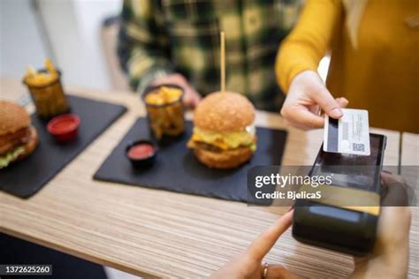 Paying For Food At Restaurant Photos And Premium High Res Pictures