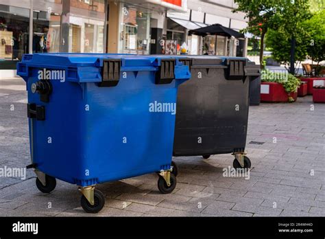 Multi Colored Plastic Containers For Collecting Garbage Standing In The