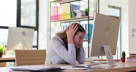 Woman Clenches Fists And Glares At Computer In Frustration Stock Video