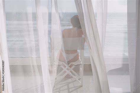 Naked Beautiful Female In The Lace Bikini Sitting On The Chair Behind