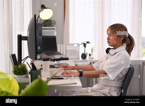 Young It Specialist Woman Checking Debugging System On Large Curved Monitor Working In Startup