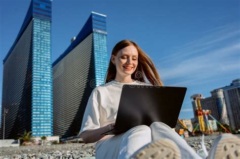 A Girl With A Laptop Works On The Beach Freelance Programmer Realtor