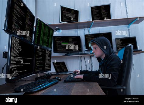 Boy Stealing Data From Multiple Computers Stock Photo Alamy