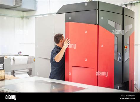 Professional Worker With Modern Big Offset Printing Machine In Print House Printing Industry