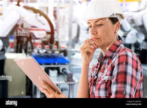 female engineer using tablet with machine real time monitoring system