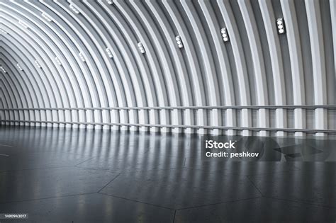 텅 빈 짙은 회색 광택 바닥이 있는 추상적인 넓은 공간에 대한 투시도 조명이 켜진 아치형 슬레이트 천장 배경에 자동차 또는 제품 프레젠테이션을 위한 장소 3d 렌더링 모형