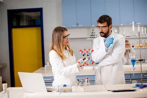 Premium Photo Chemist Couple With Safety Goggles Hold Molecular Model In The Lab