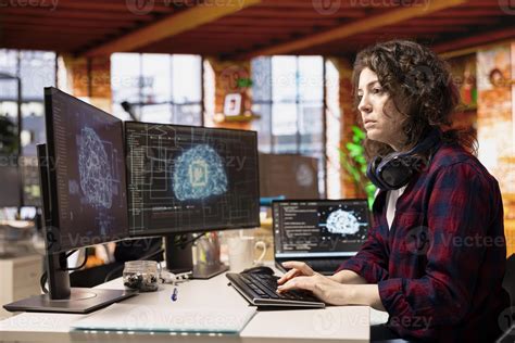 woman in artificial intelligence focused startup office designing coding and debugging