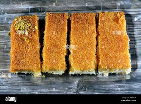 Konafa Covered With Nuts And Stuffed With Whipped Cream And Soaked With