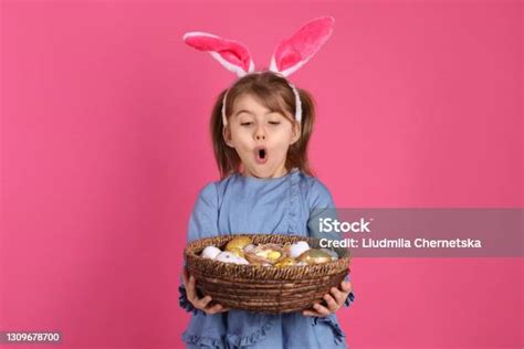 분홍색 배경에 부활절 달걀의 전체 고리버들 바구니를 들고 토끼 귀와 놀란 어린 소녀 부활절 달걀에 대한 스톡 사진 및 기타 이미지 부활절 달걀 아이 4 5세 Istock