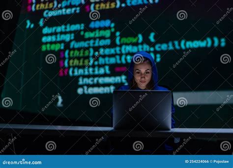 Hooded Anonymous Hacker Woman By Computer In The Dark Room At Night Cyberwar Concept Stock
