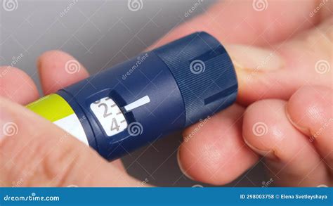 Close Up On Hands Turn Knob On Insulin Pen And Dial Up Insulin Dose For