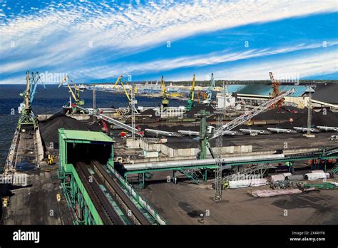 Automatic Conveyor Belt In Coal Harbor Bulk Carrier Stands Near Pier For Loading In Maritime