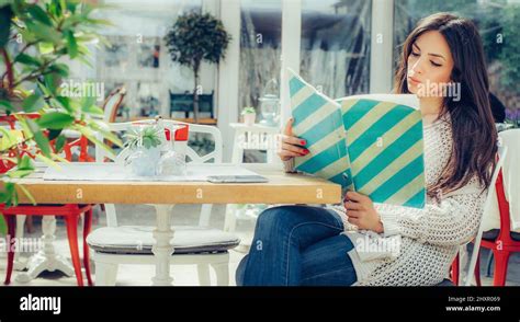 Beautiful Woman Looking At Menu And Ordering Foods In Restaurant Close