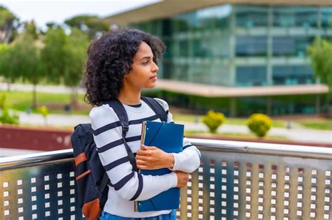 Premium Photo Latin Woman Standing Holding A Folder Outside The