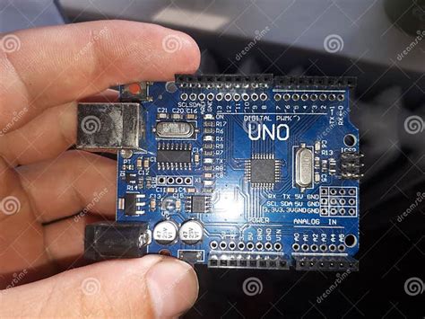 Blue Arduino Uno Board Electronics In Hand For Programming The Microcontroller Editorial Image