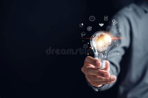 Man Holding Lightbulb With Learning Educate And Graduation Concept