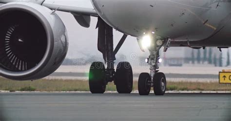 The Wheels Of A Passenger Plane Drive Down The Airport Runway After