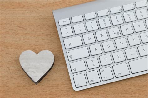 Premium Photo High Angle View Of Heart Shape With Keyboard On Wooden