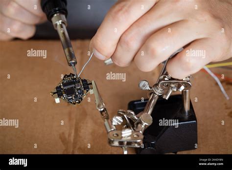 The Hand Holding The Tin A Soldering Iron Solder The Chip In Place A