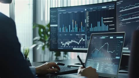 Computer Monitors Close Up Of A Male Financial Data Analyst Using A Laptop And Analyzing