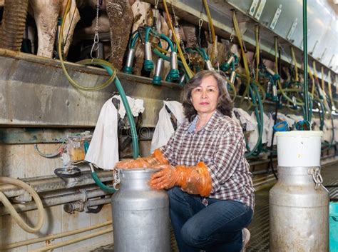 Elderly Female Sitting Near Milk Churns At Milking Parlor Stock Image Image Of Dairymaid