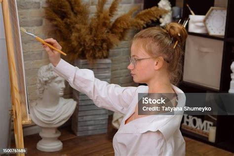 젊은 금발 여성이 작업장에서 그림을 그린다 붓과 물감을 가진 소녀 예술가 금발 예술가 드로잉 스쿨의 교사 페인팅 교육 주문할 그림 교육에 대한 스톡 사진 및 기타 이미지
