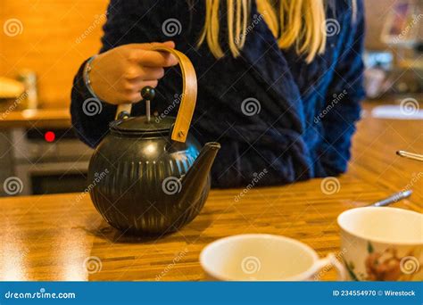 Woman Holding The Handle Of A Tea Kettle Stock Photo Image Of Holding Female 234554970