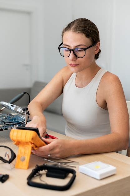 Premium Photo Young Female Inventor Creating In Her Workshop
