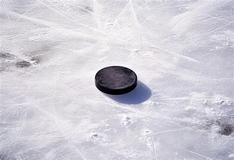 Premium Ai Image Detailed Closeup Of A Used Hockey Puck On A Textured