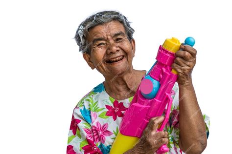 Premium Photo Portrait Of Senior Woman With Squirt Gun Standing