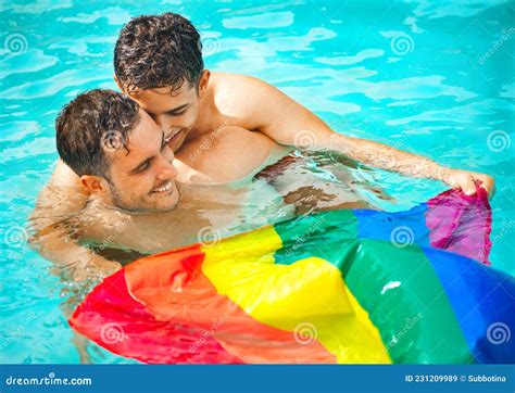 Gay Couple Relaxing In Swimming Pool With Lgbt Flag Two Young Men