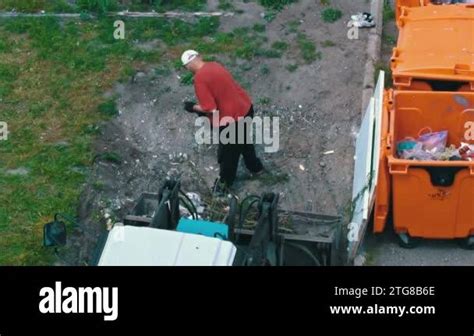 Man With A Shovel Loads Garbage Into A Tractor Tank The Garbage Truck Is Working Hard Garbage