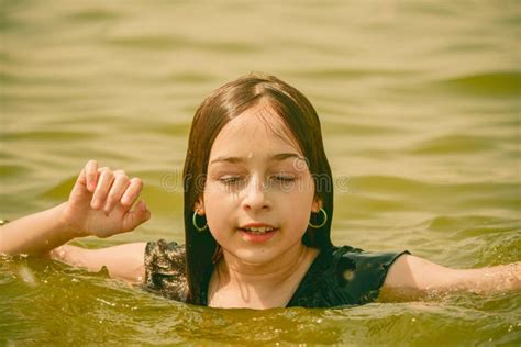 A Girl Swims In The River Close Up Of Young Beautiful Girl In Water