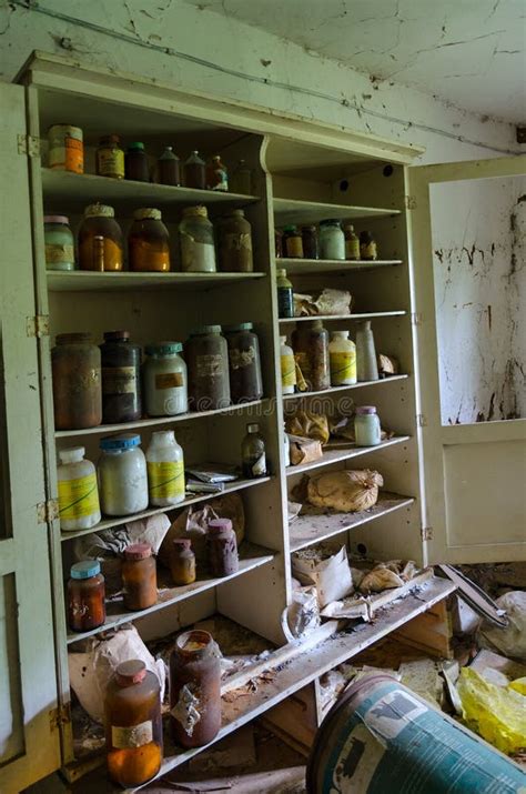 Dusty Glass Jars With Drugs In Cabinet In Former Veterinary Laboratory