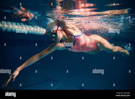 Activity Young Sportive Woman Professional Swimmer Training In Swimming Pool Indoor Wearing