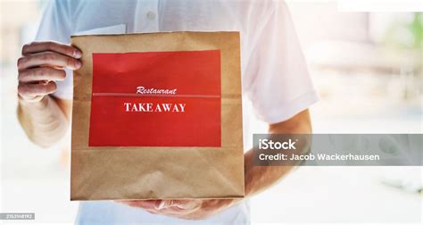 남자 배달 및 레스토랑 테이크 아웃 야외 패키지 및 패스트 푸드 소포에 대한 온라인 주문 손 남성 및 식사 또는 점심 서비스의 배포 저녁 식사 가방의 테이크 아웃과 택배