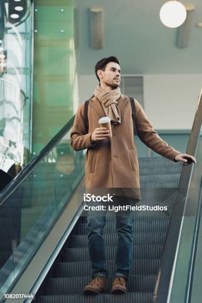 에스컬레이터에 추락 하 고 일회용 컵을 들고 잘생긴 남자 남자에 대한 스톡 사진 및 기타 이미지 남자 마실 것 방한 의류 Istock
